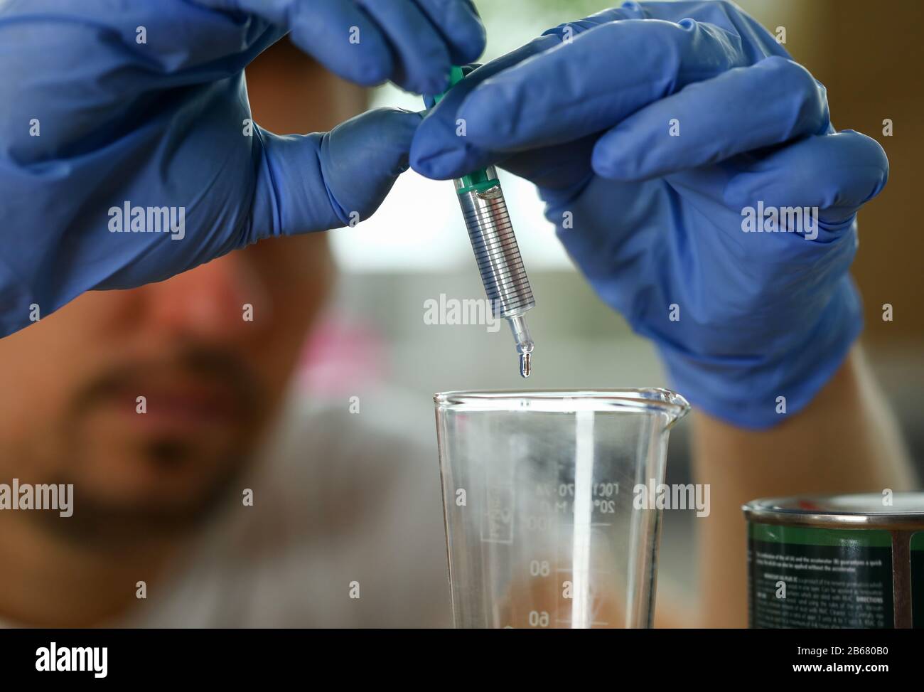 Worker trickling liquid Stock Photo - Alamy
