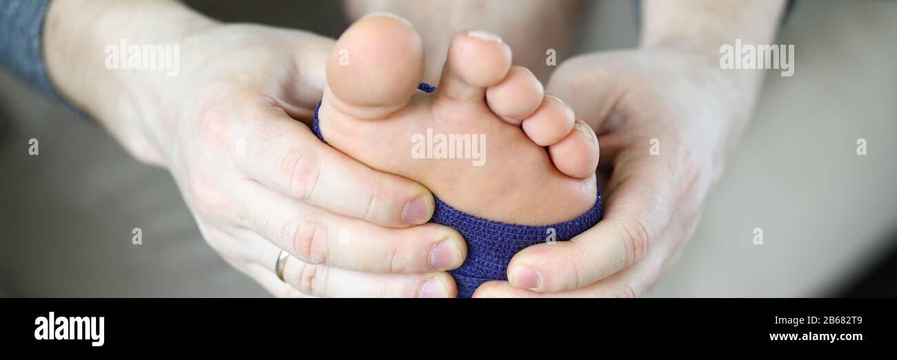Human holding foot with hand Stock Photo - Alamy