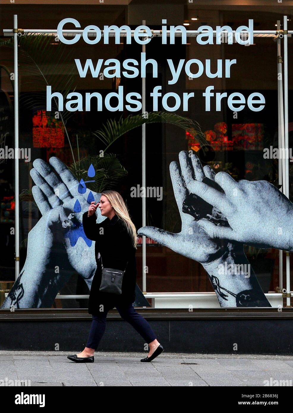 A lady walks past a sign in the window of a Lush store in Liverpool ...