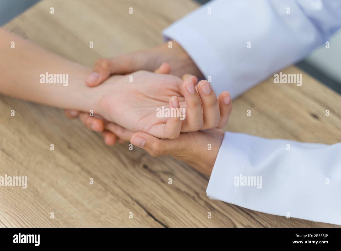 Close up of a doctor holding the patient hands doing basic medical ...