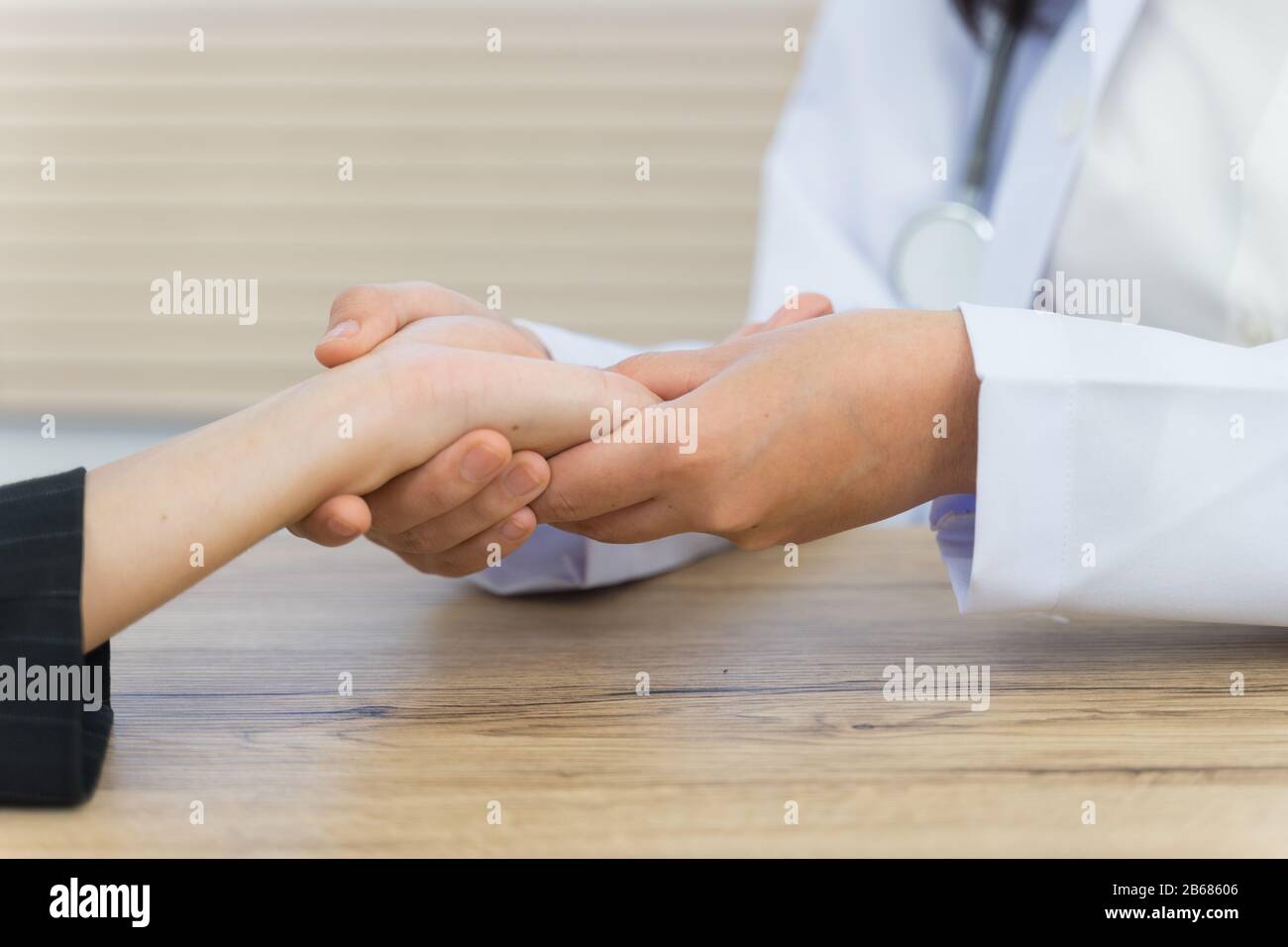 Close up of a doctor holding the patient hands doing basic medical ...
