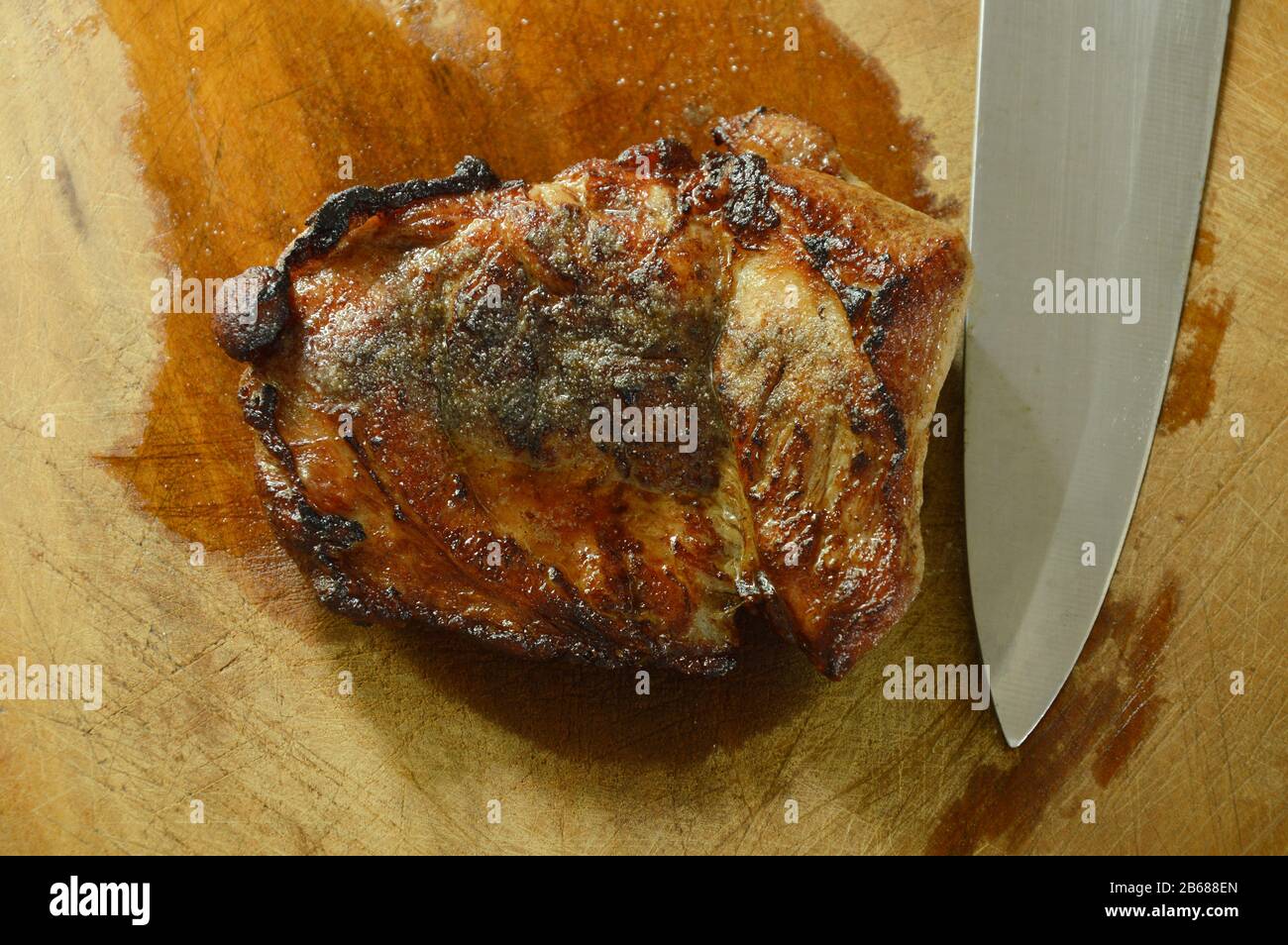 pepper pork steak and knife blade on wooden chop block Stock Photo - Alamy