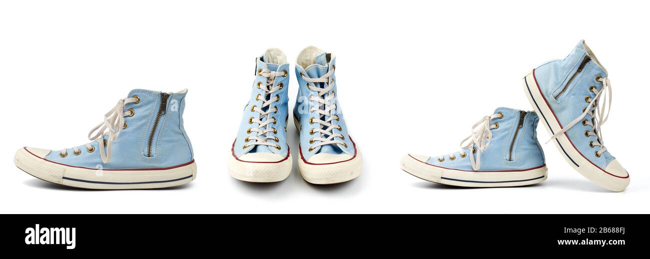 pair of light blue worn textile sneakers with laces and zippers ...