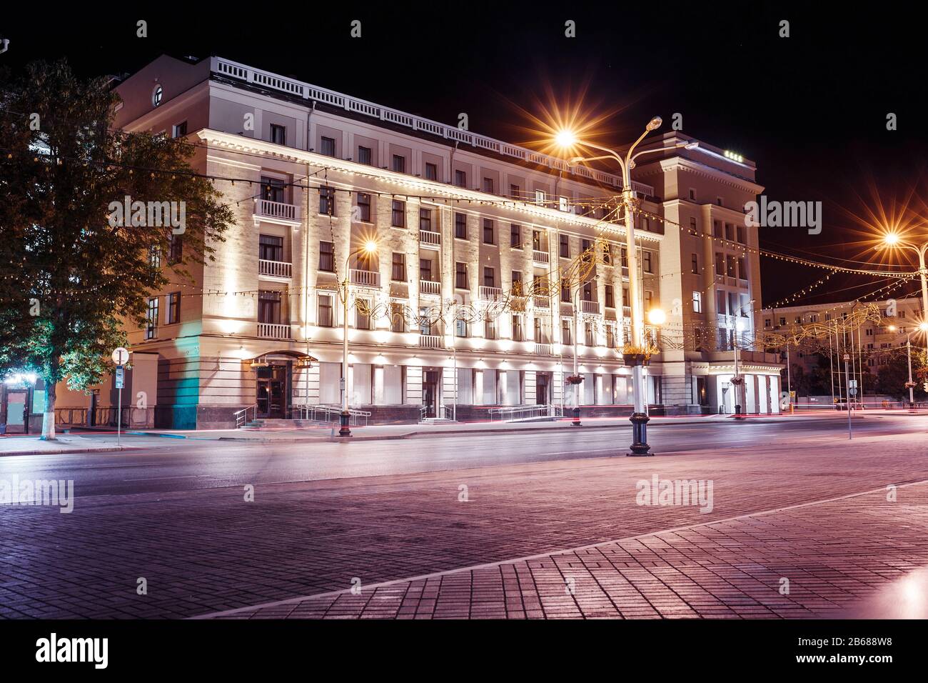 Night empty street in the center of Ufa, Russia with a lighted building ...