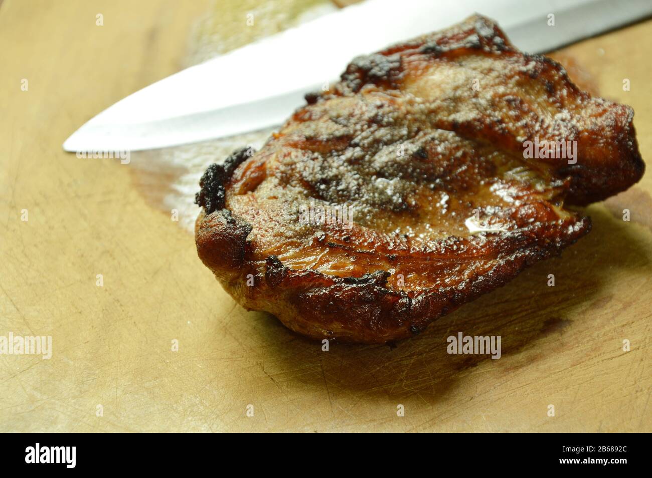 pepper pork steak and knife blade on wooden chop block Stock Photo - Alamy