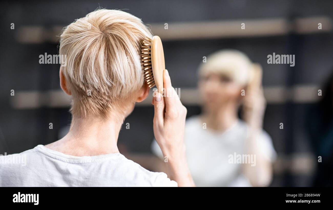 Brushing hair back hi-res stock photography and images - Alamy