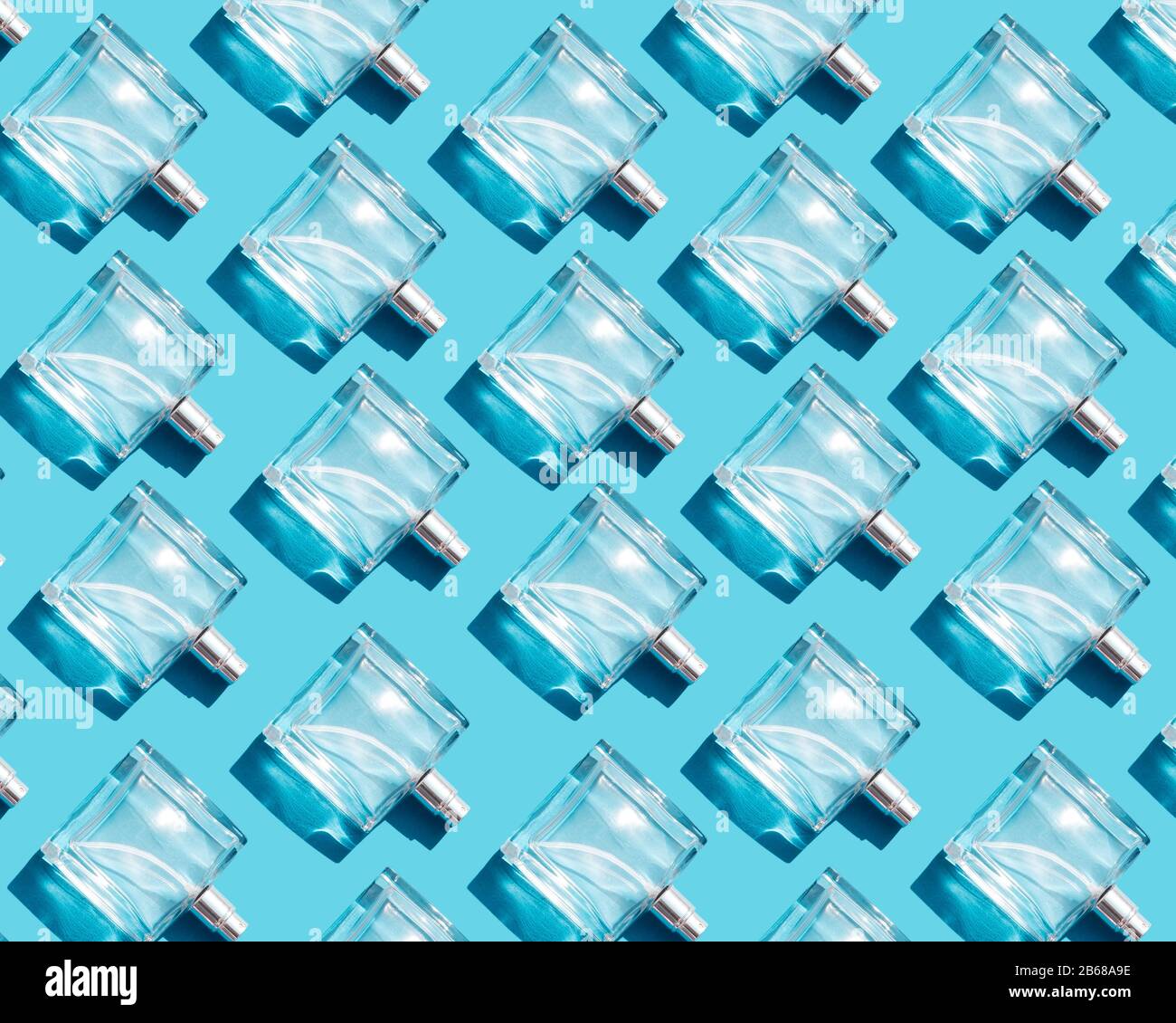 Perfume bottles pattern on blue background Stock Photo - Alamy
