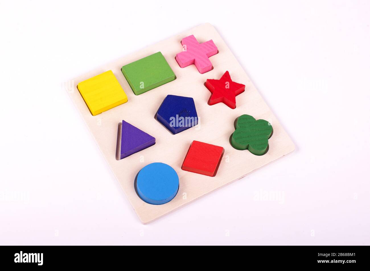 Wooden kindergarten shape puzzle game isolated on the white background ...