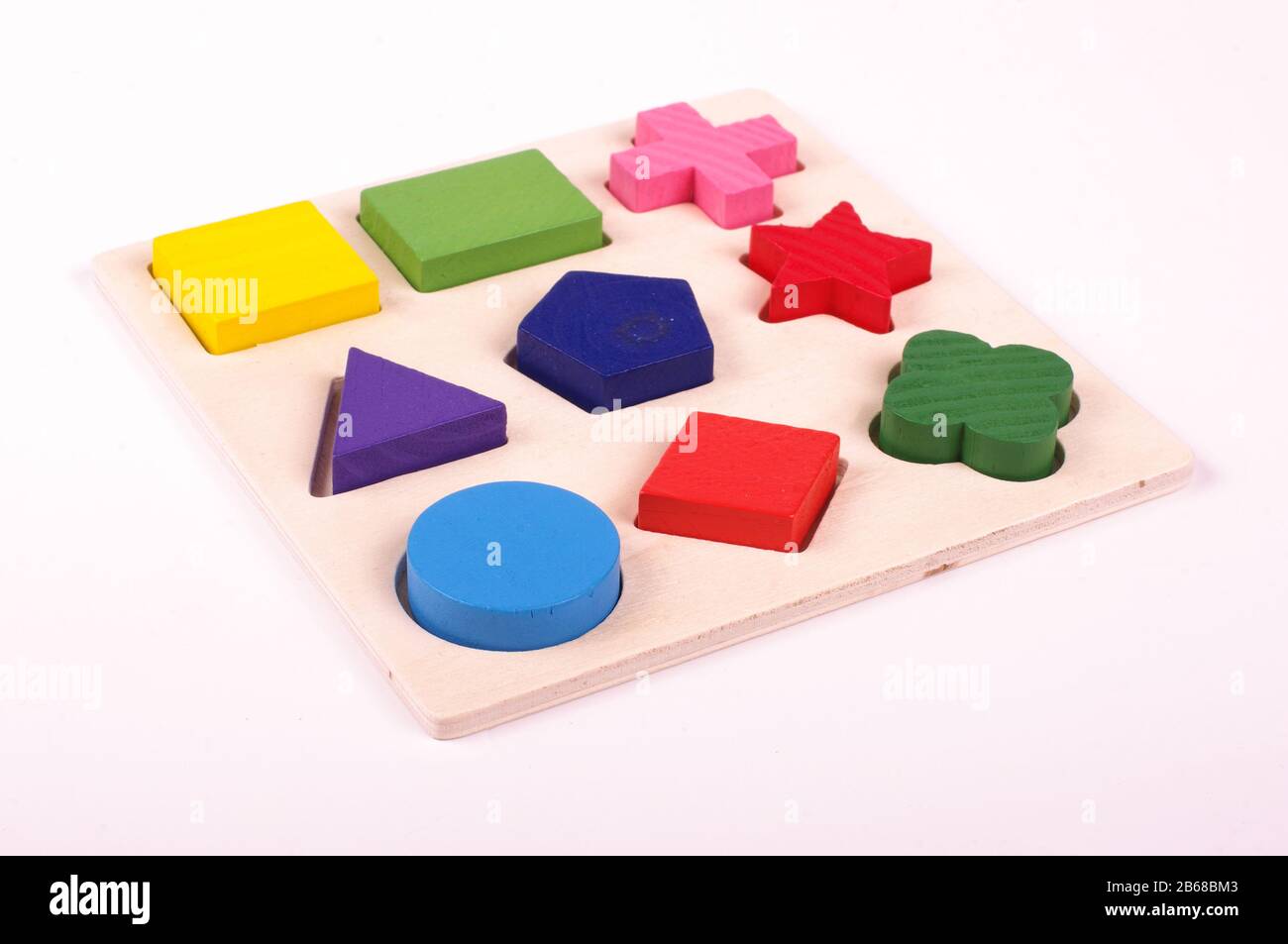 Wooden kindergarten shape puzzle game isolated on the white background ...