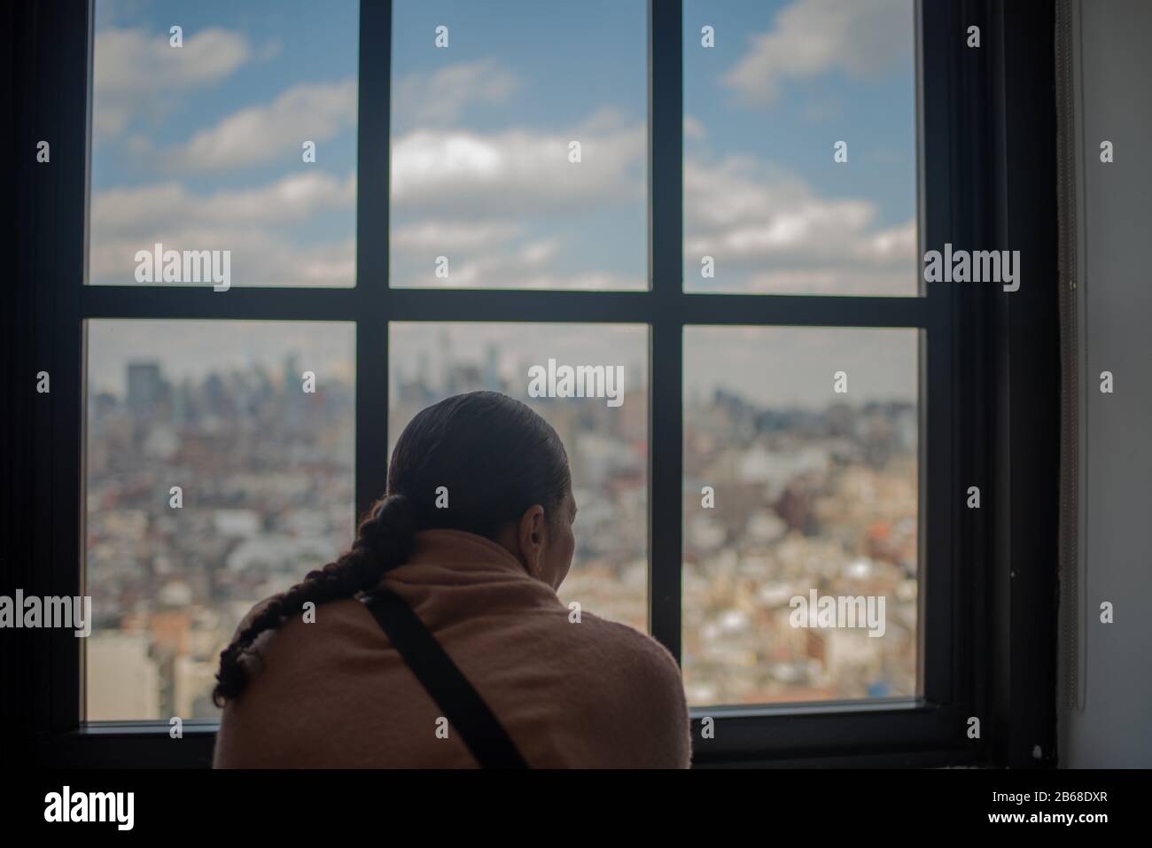 Woman staring through window shot from behind Stock Photo - Alamy