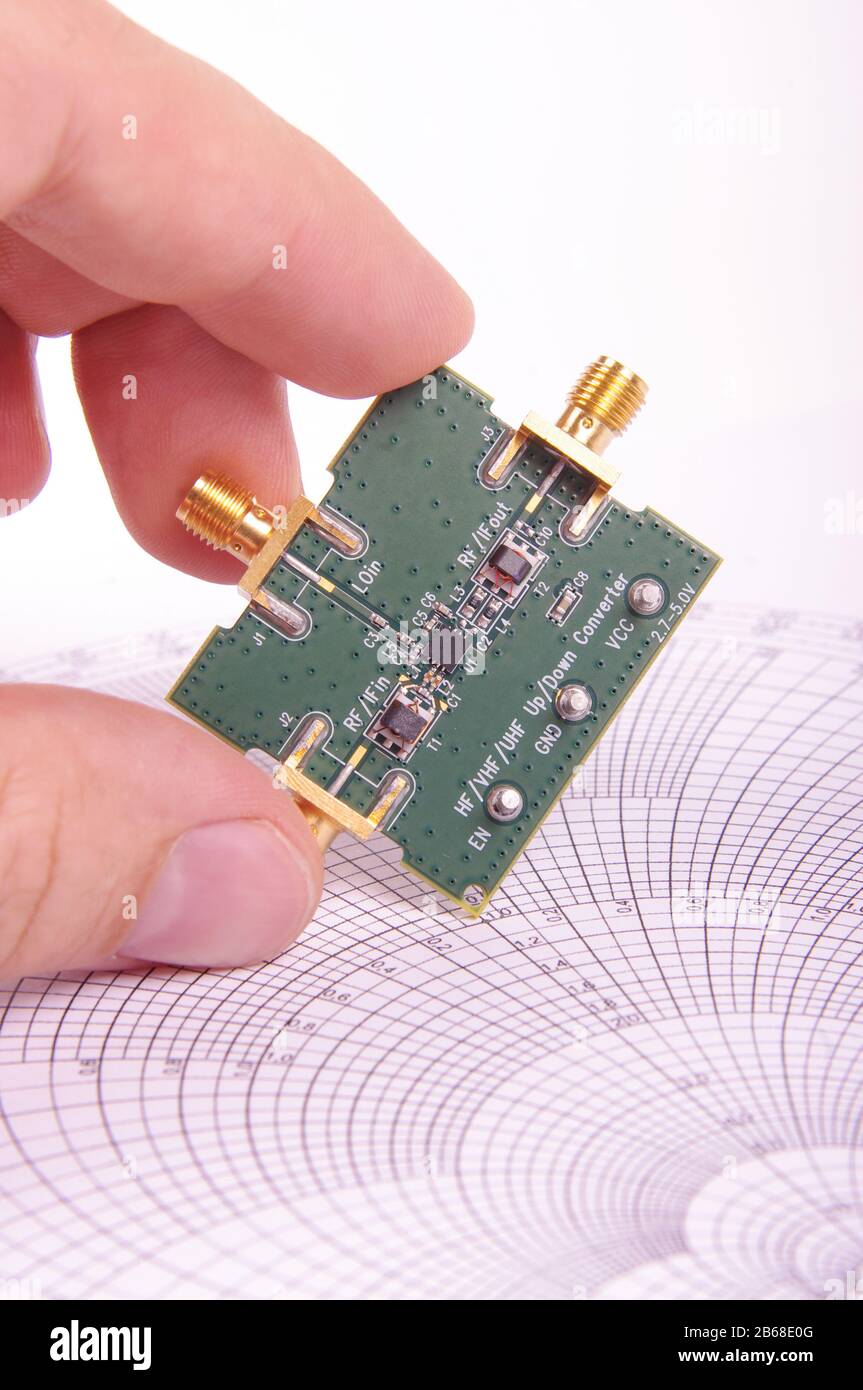 Radio frequency engineer inspect microwave mixer printed circuit board ...