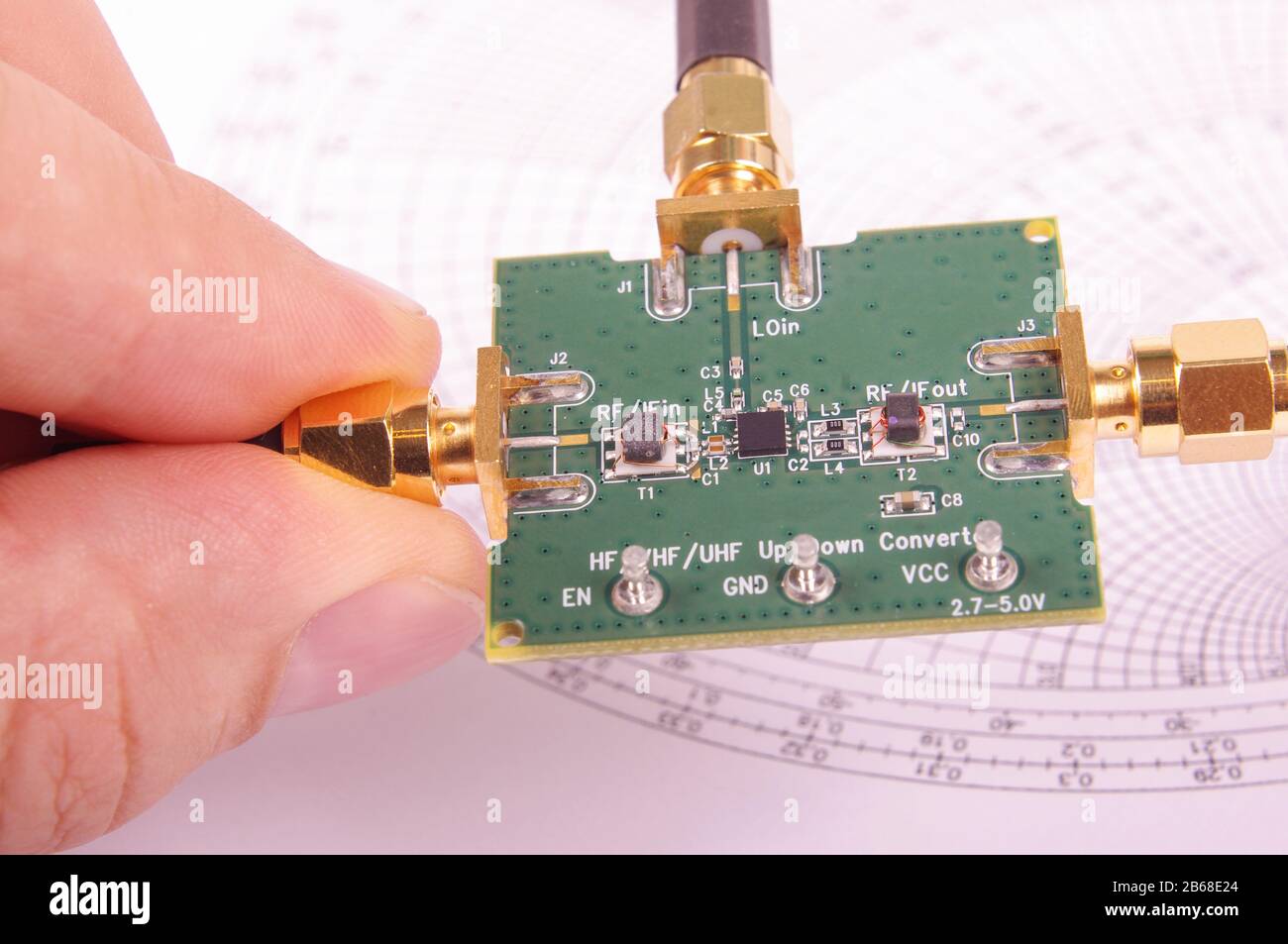 Radio frequency engineer inspect microwave mixer printed circuit board ...