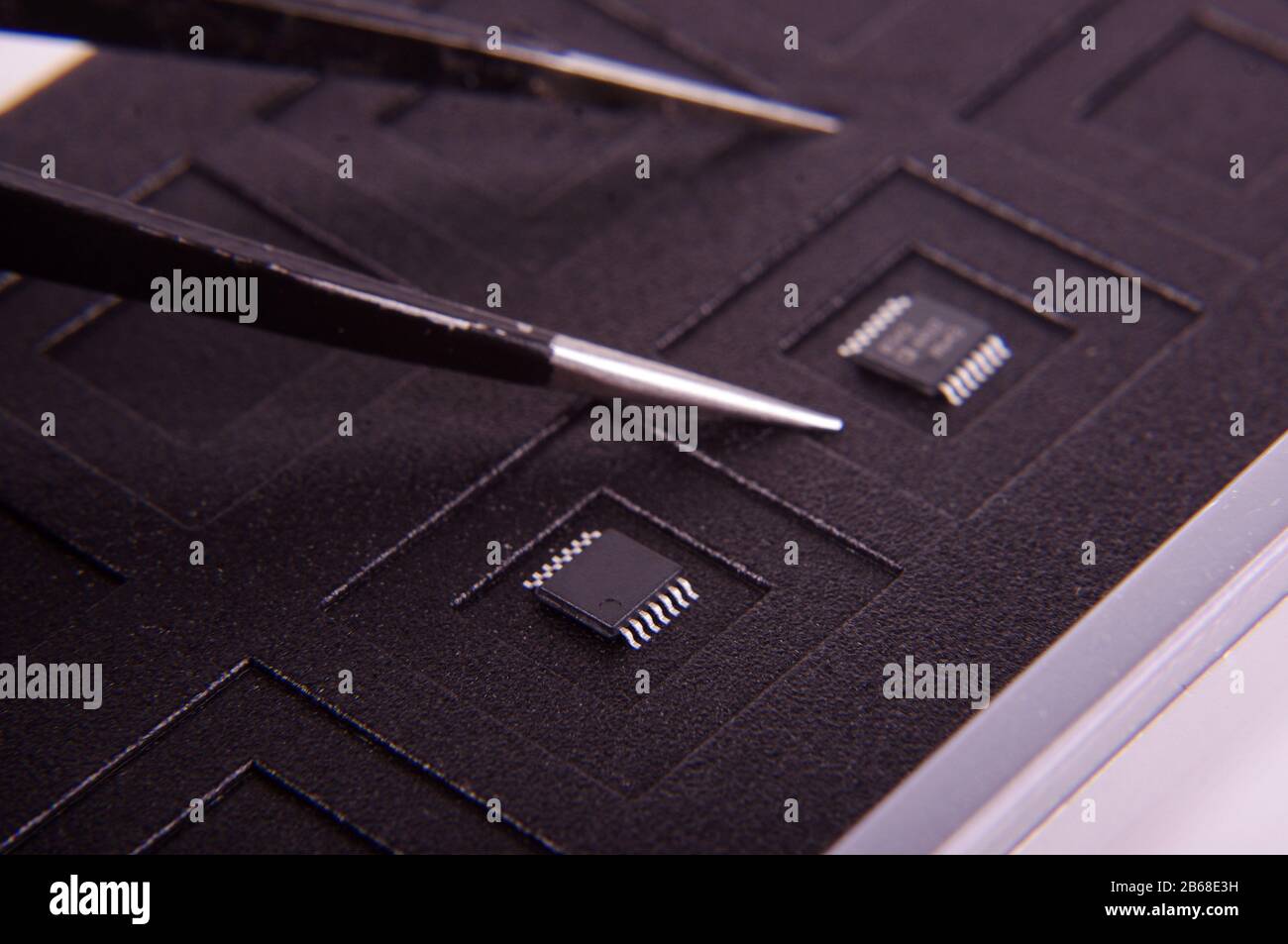Tiny SMT technology electronics chip component on the antistatic mat ...