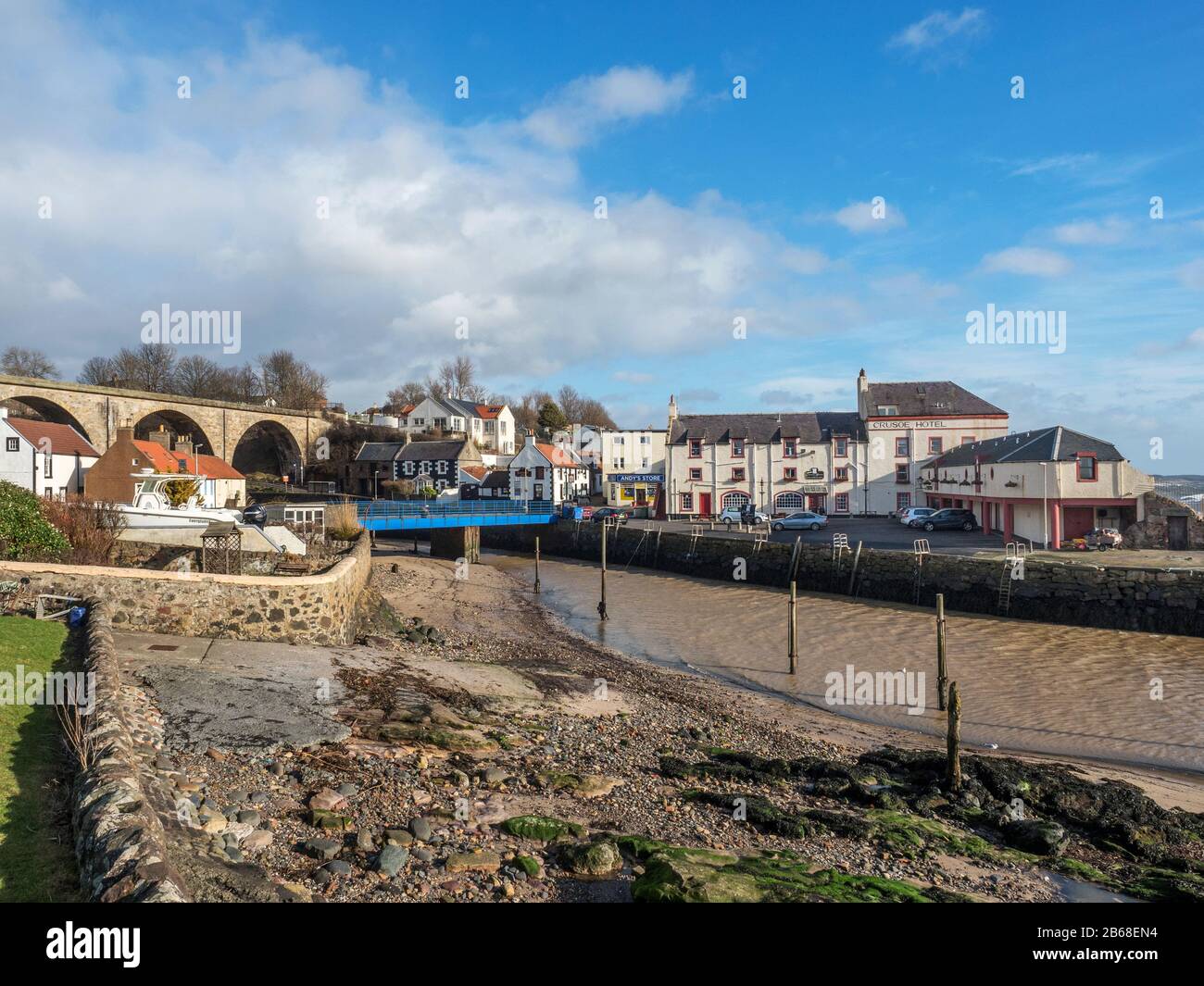 Harbour with old railway viaduct and Crusoe Hotel at Lower Largo Fife ...