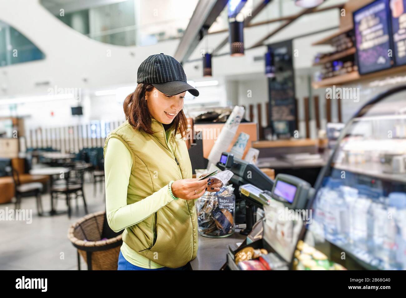 Young woman customer paying with credit card in a coffee shop Stock ...