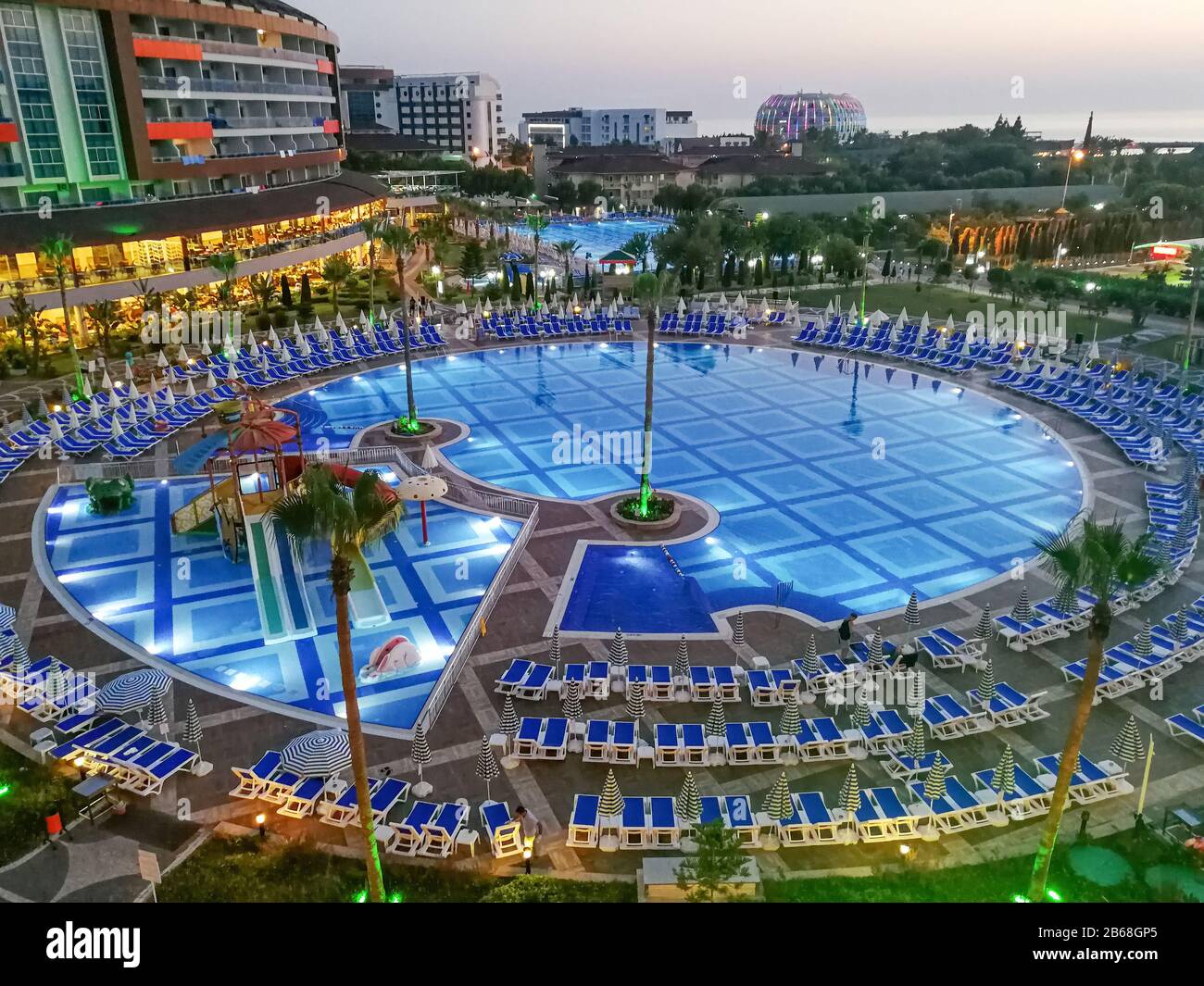 Big and luxury swimming pool of the hotel at evening. Holidays concept ...