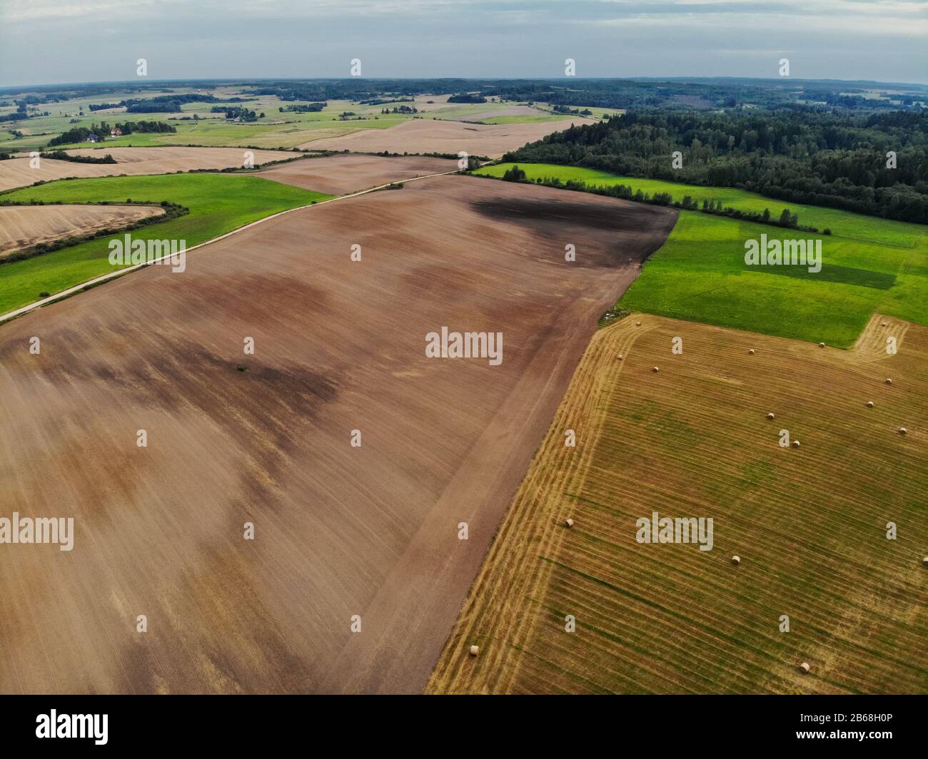 Aerial photography of autumn farm fields near Kraziai town in Lithuania ...