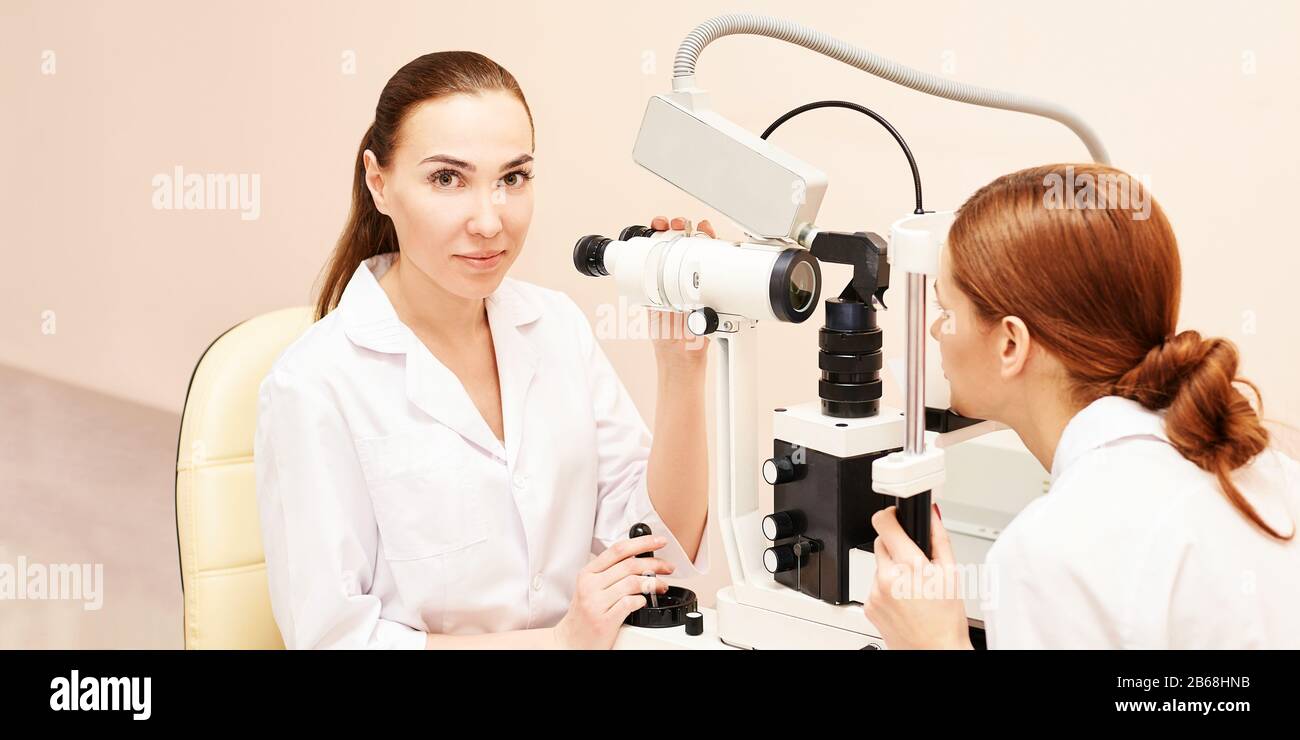 ophthalmologist doctor in exam optician laboratory with female patient ...