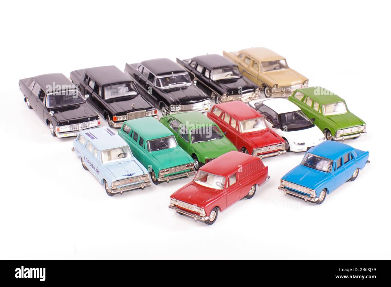 Collection of vintage metal die-cast car models isolated on the white ...