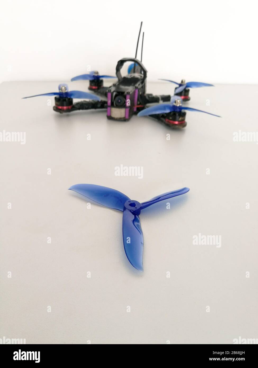 Plastic blue drone propeller in front of racing quadcopter Stock Photo ...