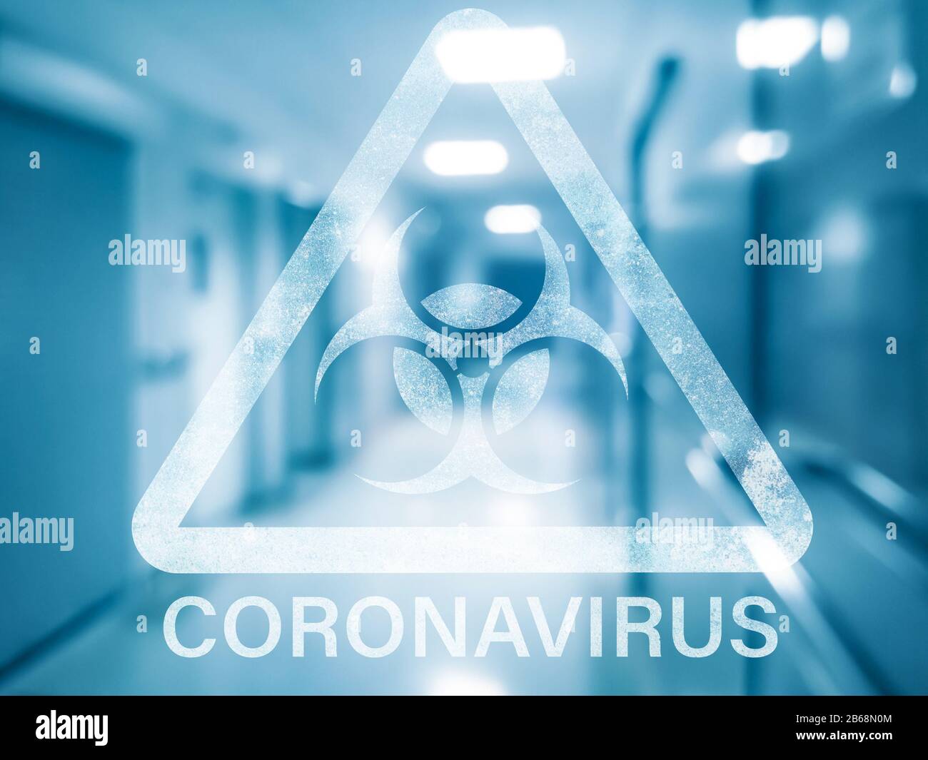 Coronovirus triangle biohazard warning sign on a blurred background of ...