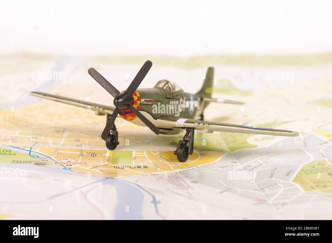 Old World War II model plane placed on the city map Stock Photo - Alamy