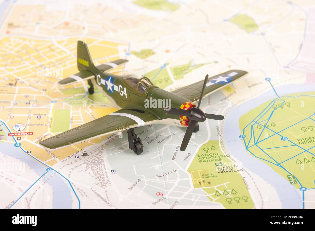 Old World War II model plane placed on the city map Stock Photo - Alamy