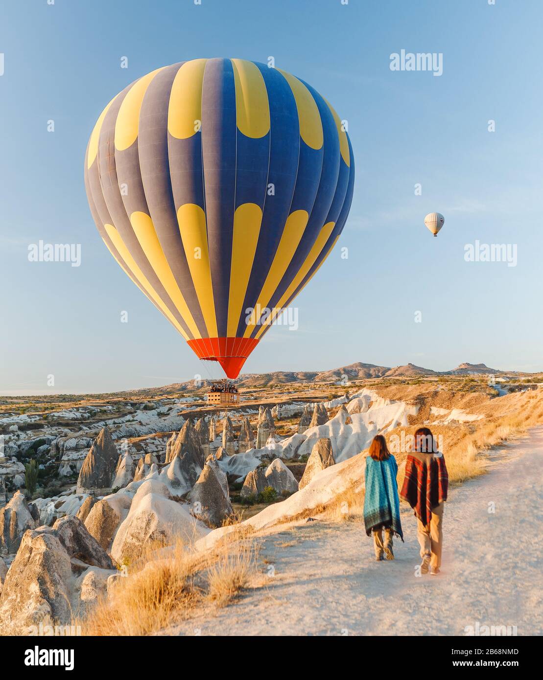 A tourist girl on a mountain top enjoying wonderful view of the sunrise ...