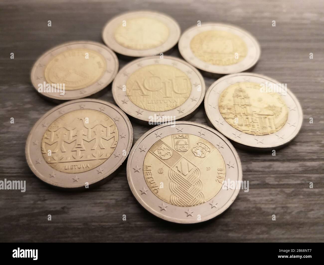 Collection of all commemorative 2 euro coins on the wooden background ...