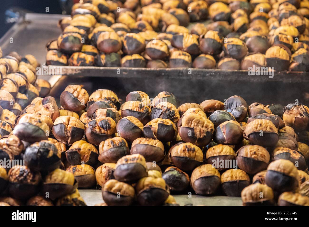 Roasted fried chestnuts. Street food grill chestnut Stock Photo - Alamy