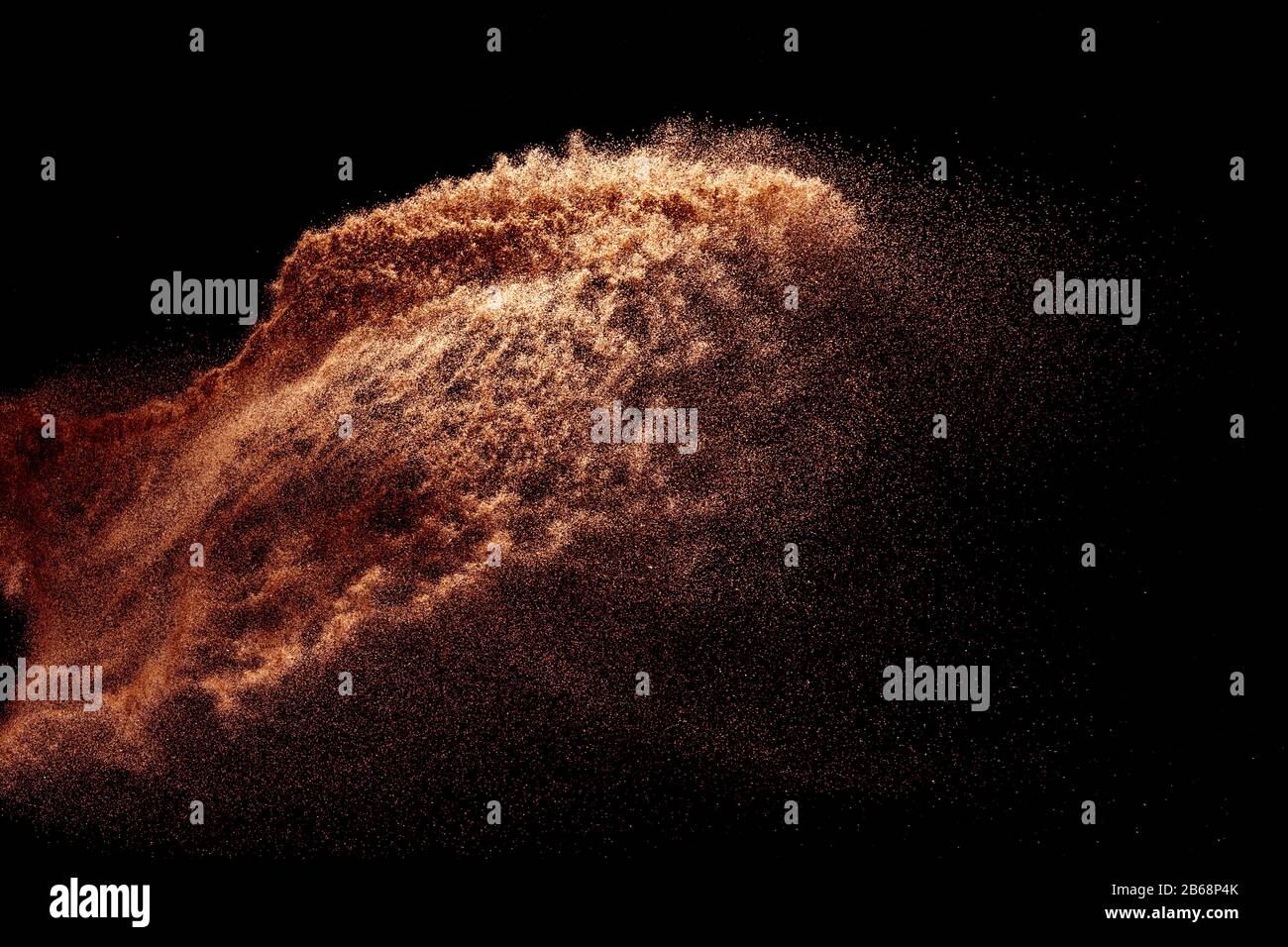 Brown colored sand splash.Dry river sand explosion isolated on black ...