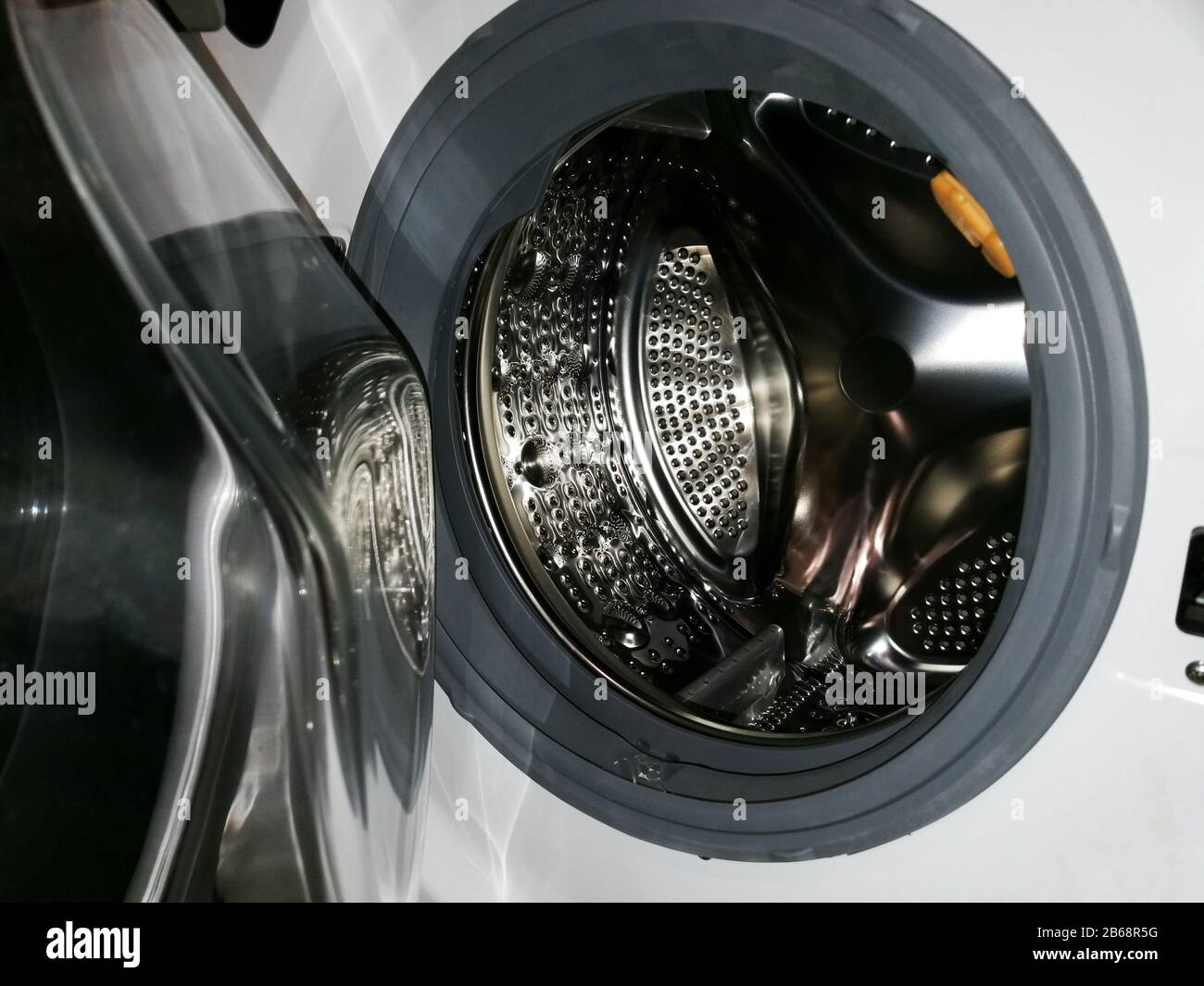 Washing machine drum with many holes internal view Stock Photo - Alamy