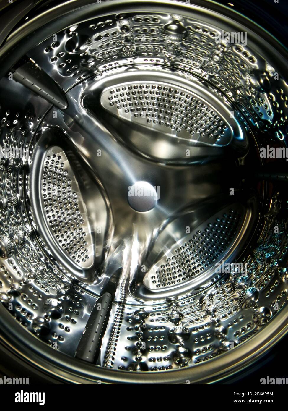 Washing machine drum with many holes internal view Stock Photo - Alamy
