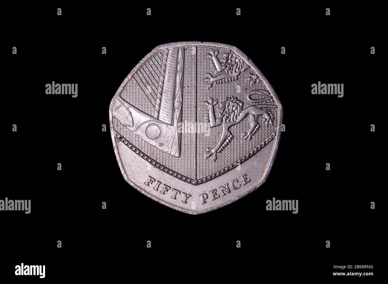 Commemorative 50 penny United Kingdom coin isolated on the black ...