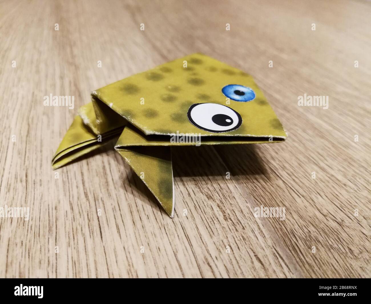 Origami frog with crazy eyes folded from paper close up Stock Photo - Alamy