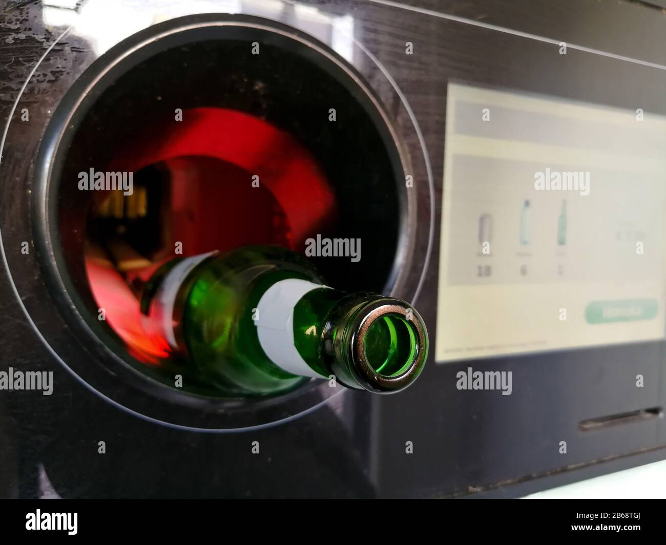 Green glass beer bottle close up inserted in the automatic reverse ...