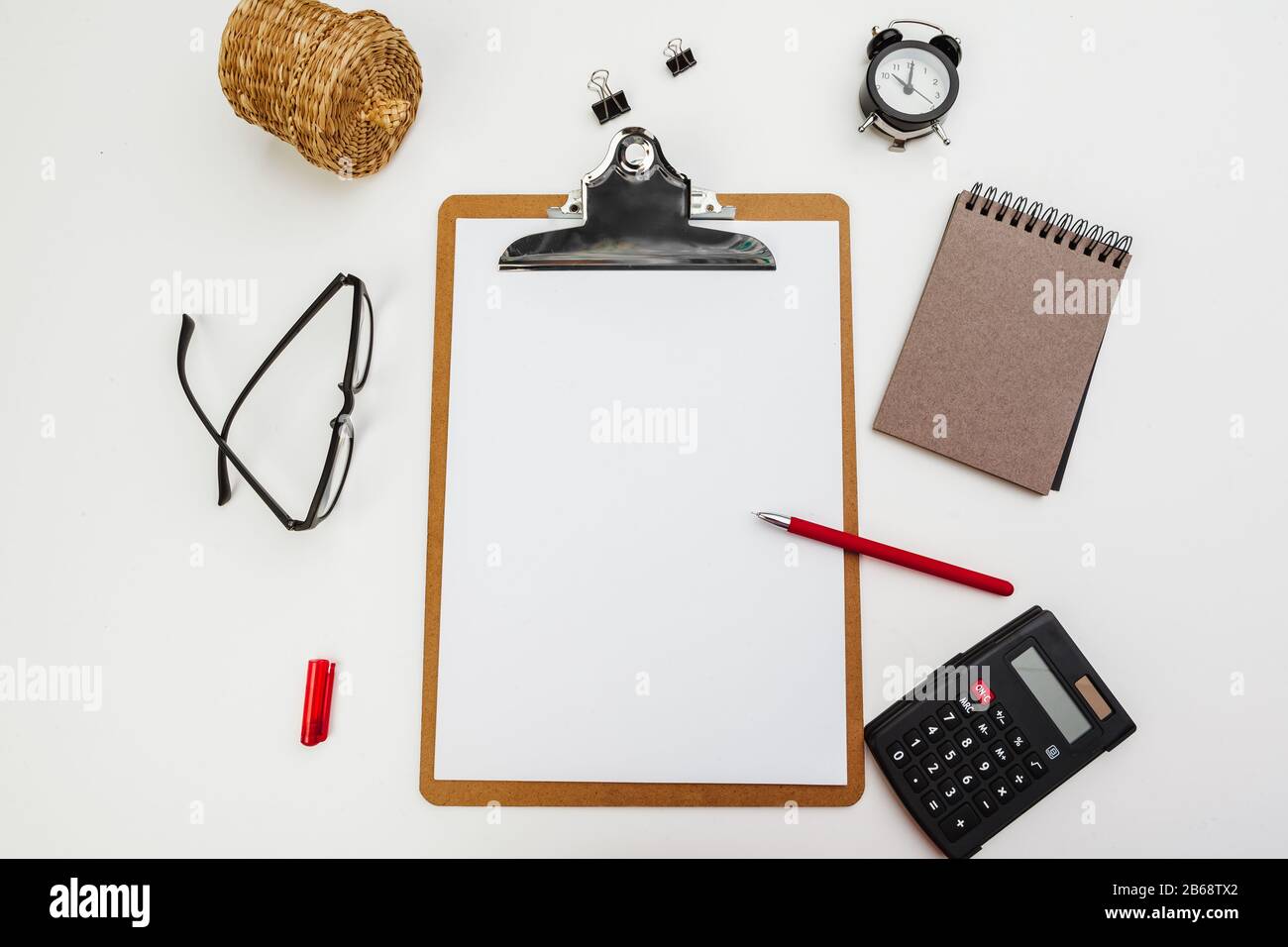 Clipboard with office supplies on white table, top view Stock Photo - Alamy