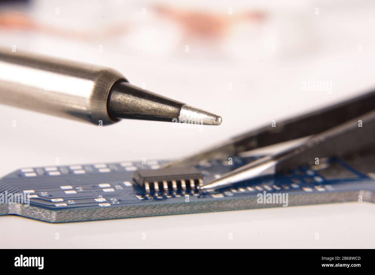 Small electronics integrated circuit IC on empty printed circuit board ...