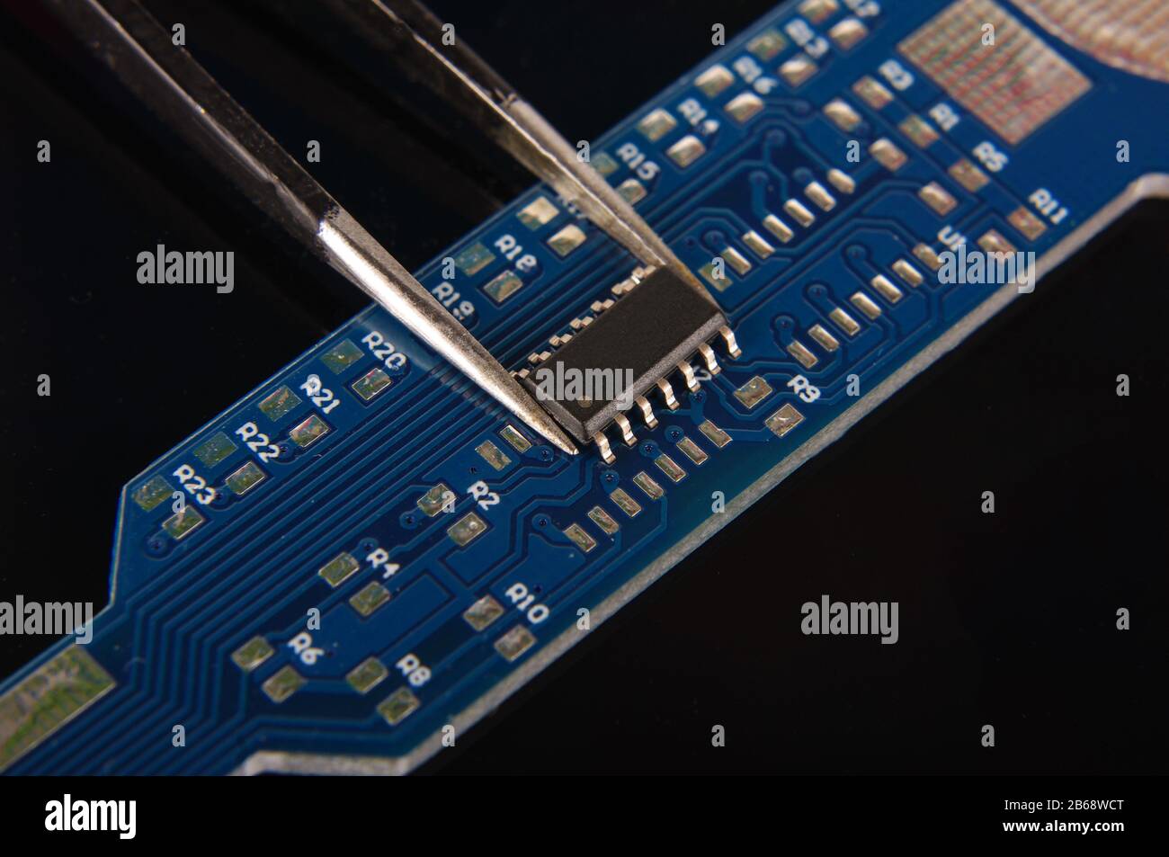 Small electronics integrated circuit IC on empty printed circuit board ...