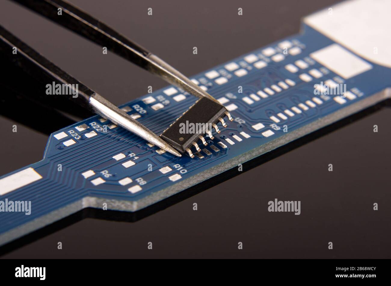 Small electronics integrated circuit IC on empty printed circuit board ...