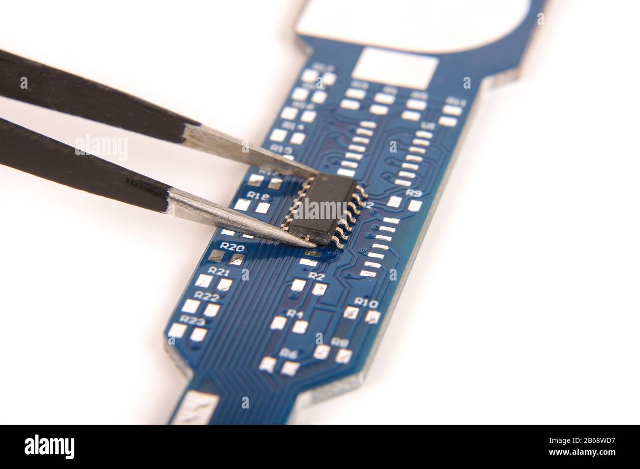 Small electronics integrated circuit IC on empty printed circuit board ...