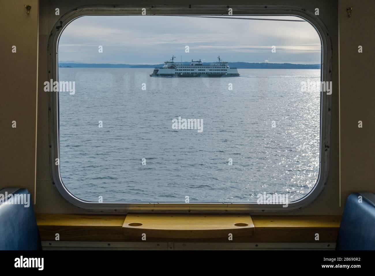 View across water from a ferry boat window, a ferry in Puget Sound ...