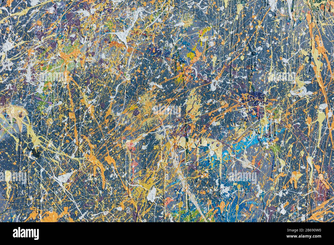 Colorful graffiti paint splattered and dripping on urban wall, close up ...