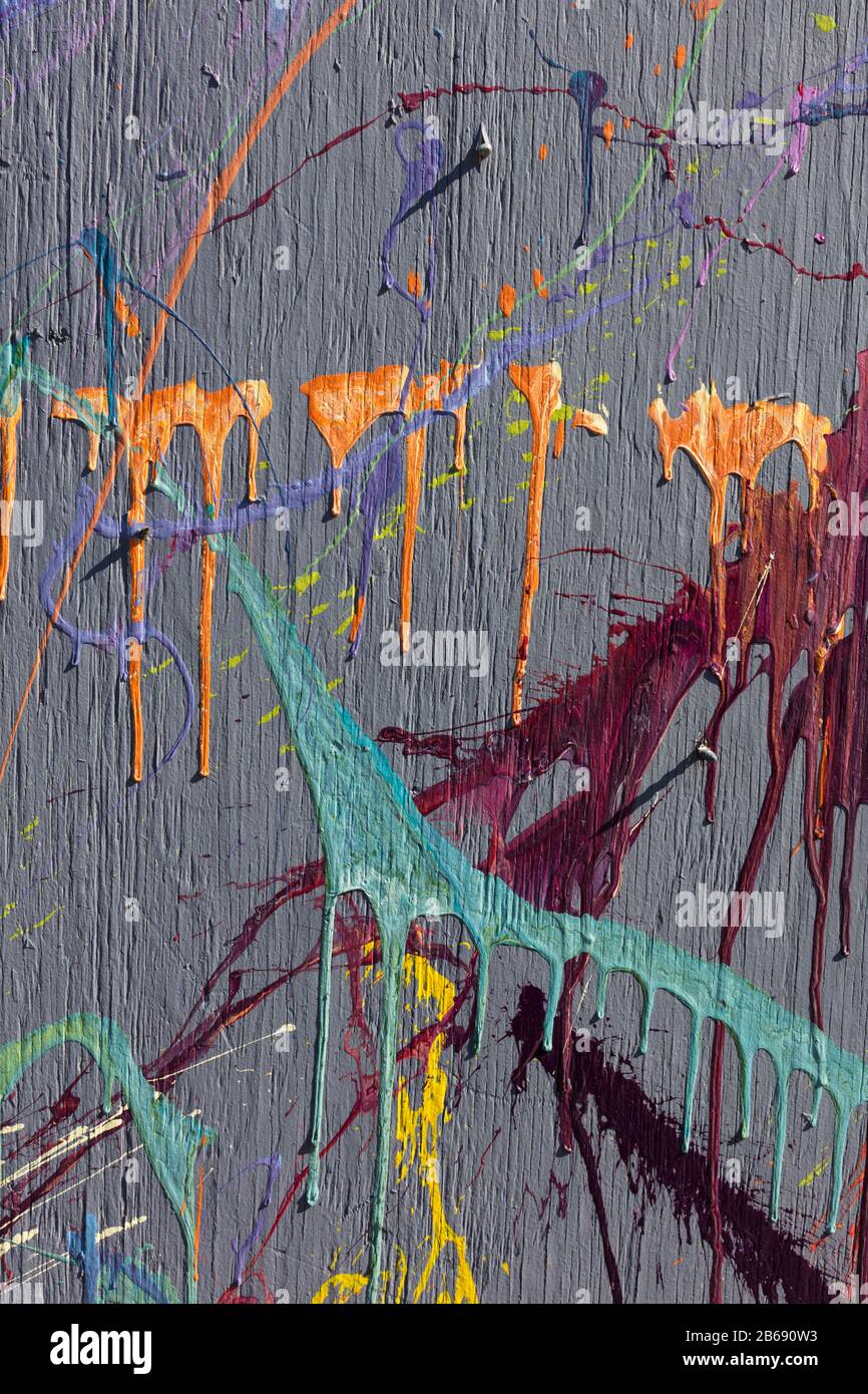 Colorful graffiti paint splattered and dripping on urban wall, close up ...