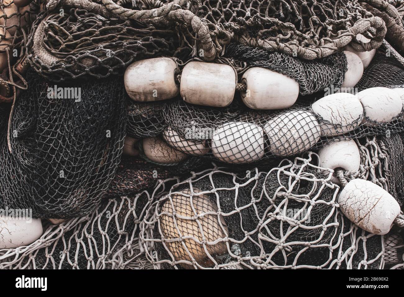 Pile of commercial fishing nets and gill nets on a fishing quay Stock ...