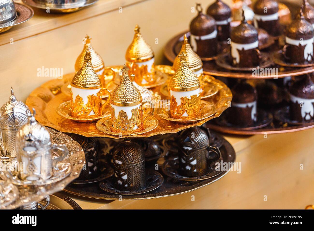 Tea and coffee set with traditional golden cups on the oriental market ...