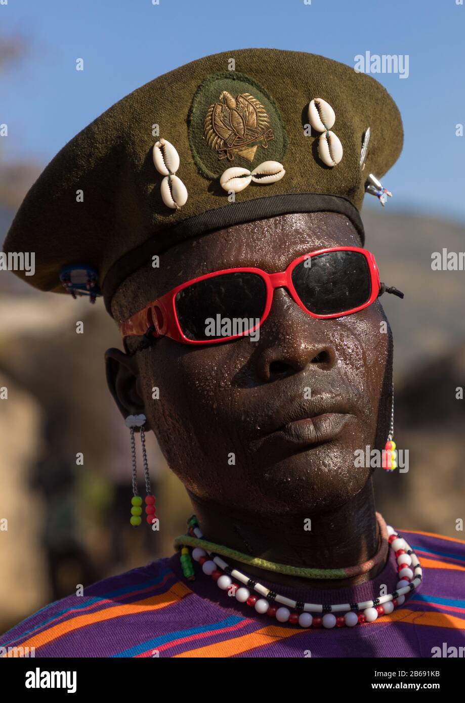 Larim tribe man with sunglasses during a wedding ceremony, Boya ...