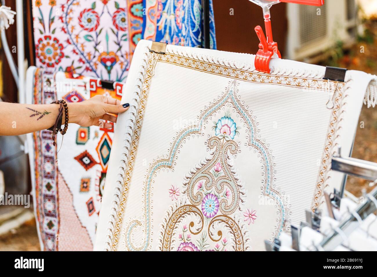 Woman chooses traditional muslim arabic carpet at turkish Grand Bazaar ...