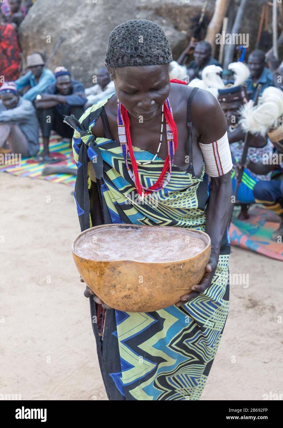 Larim tribe woman carrying alcohol in a calabash during a wedding ...