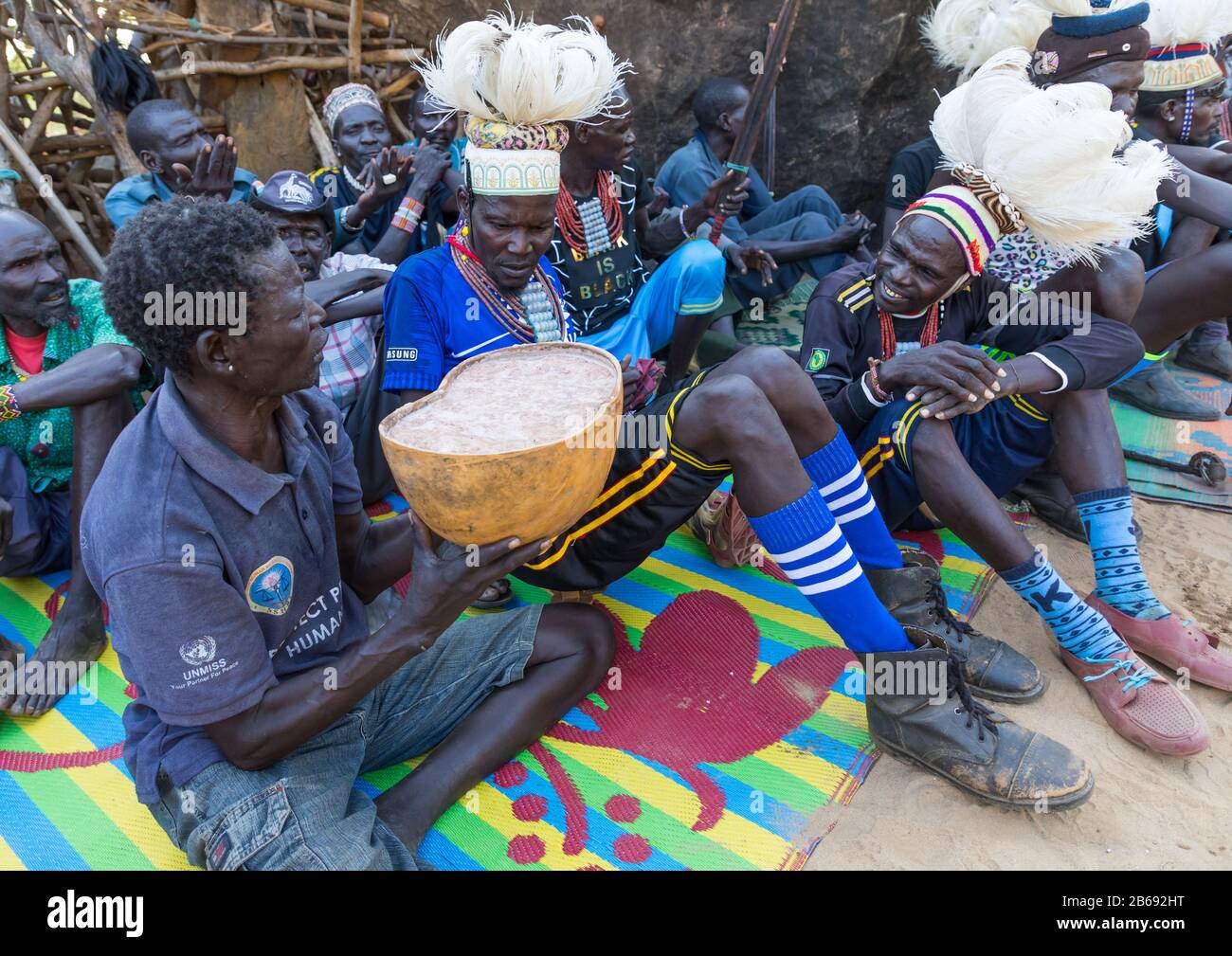 Larim tribe men drinking alcohol in a calabash during a wedding ...